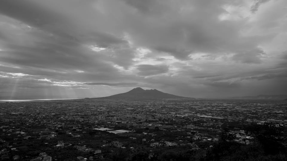 Mount Vesuvius Casts Its Shadow Over Below The Clouds